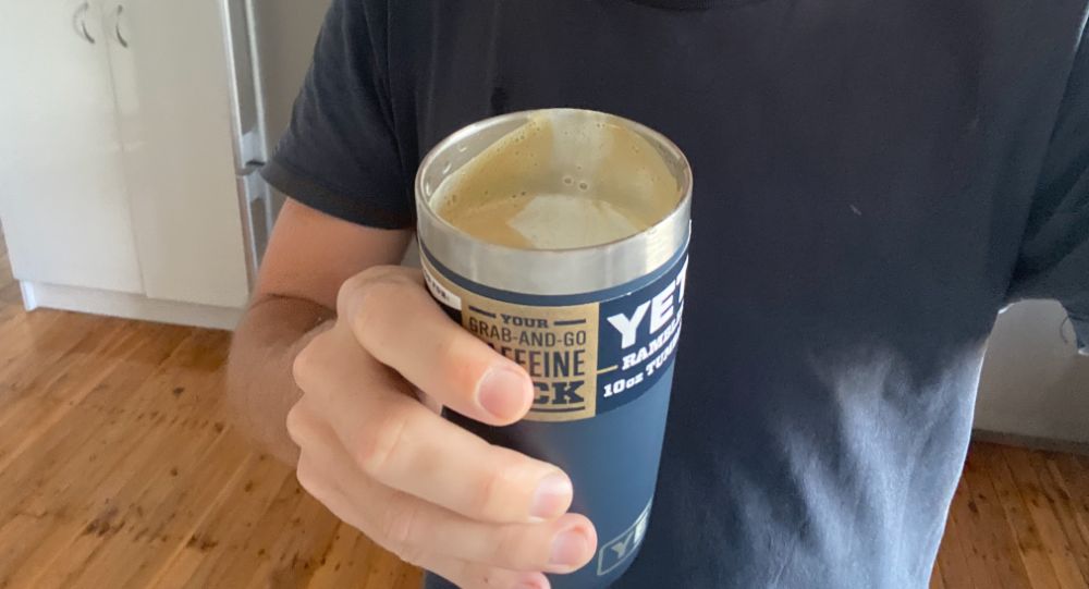 Holding yeti 10 oz tumbler cup filled with coffee The Cooler Box Holding yeti 10 oz tumbler cup filled with coffee The Cooler Box